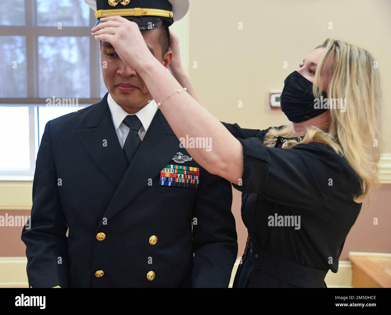 Lt. j.g. Shane Datugan's family assists with the Officer's shoulder ...
