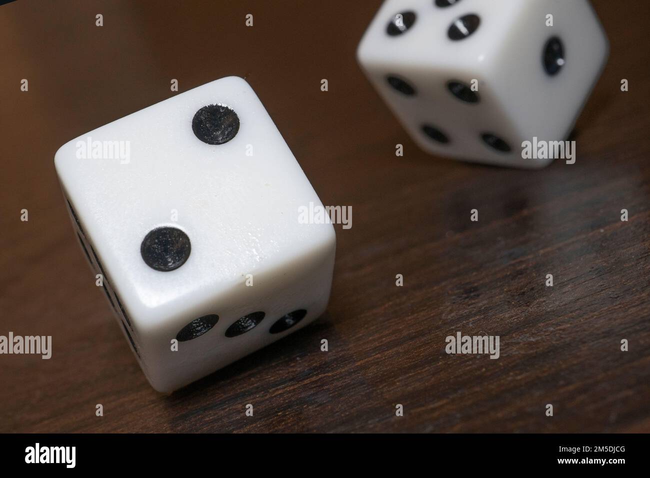 A closeup shot of gambling dice on a wooden table Stock Photo - Alamy