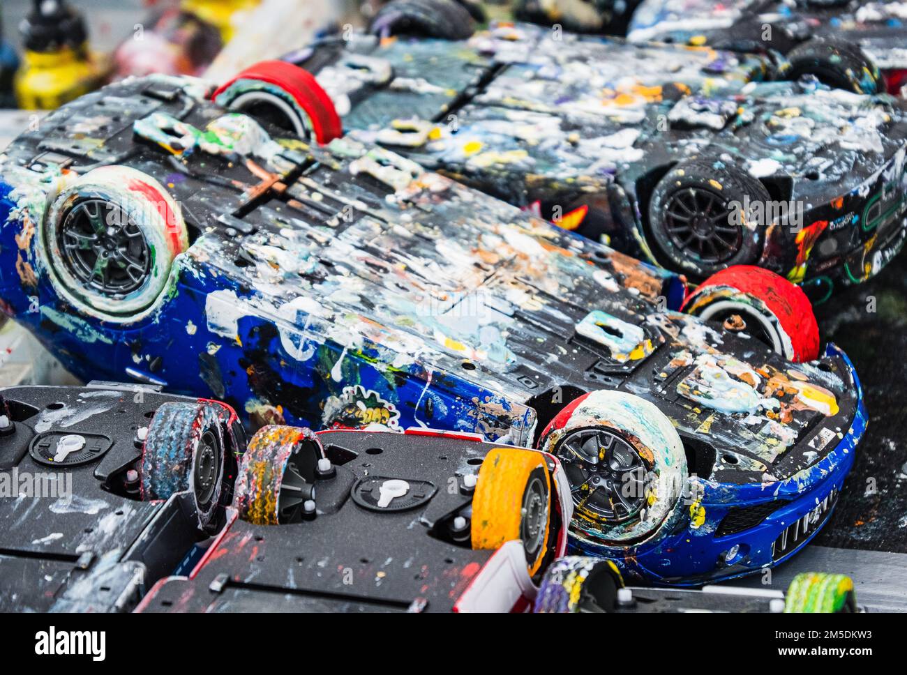 A close-up shot of toy cars wheels splattered with paints used for ...
