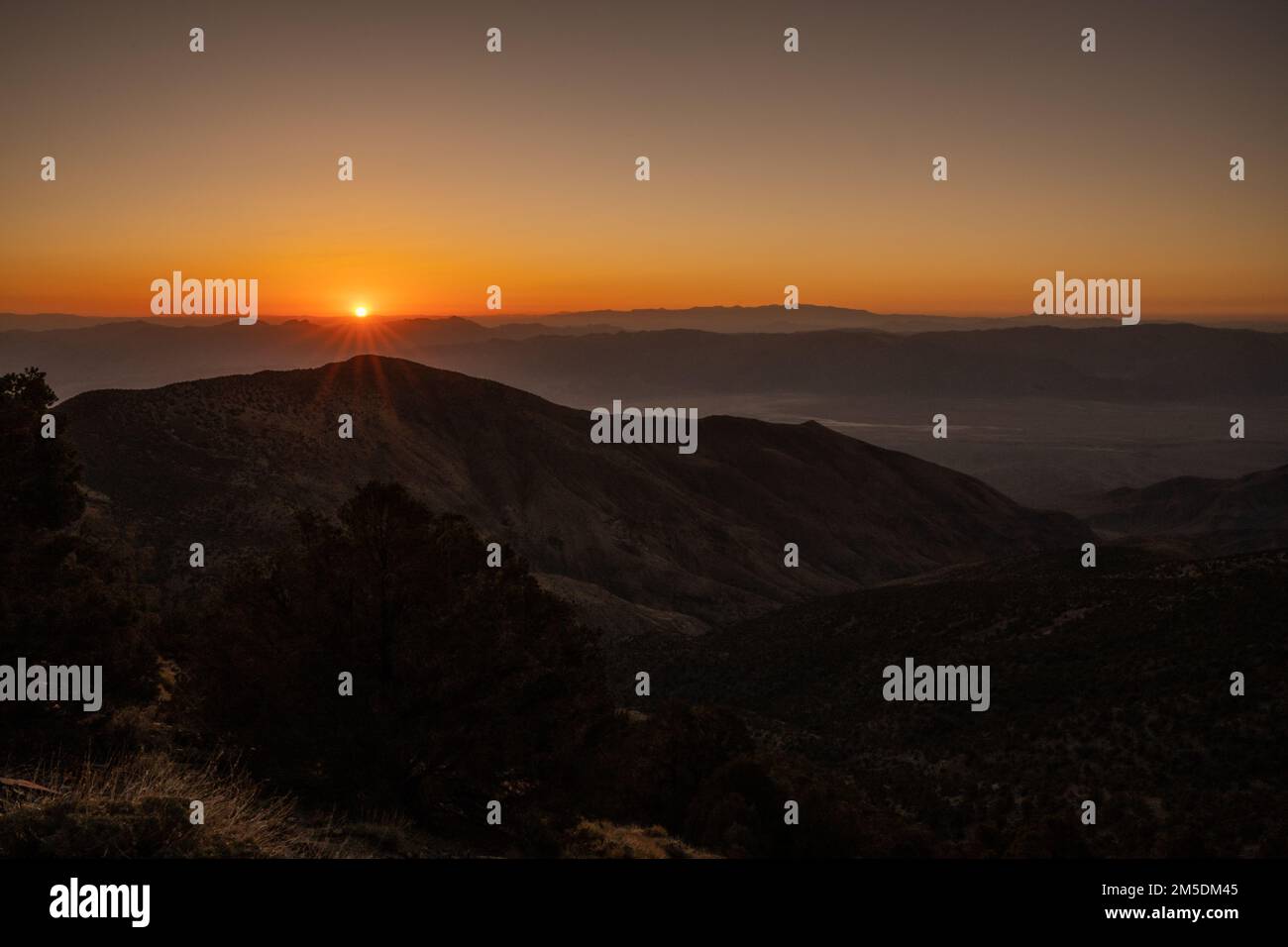 Orange Sunburst Rises Over the Death Valley Mountains above Badwater ...