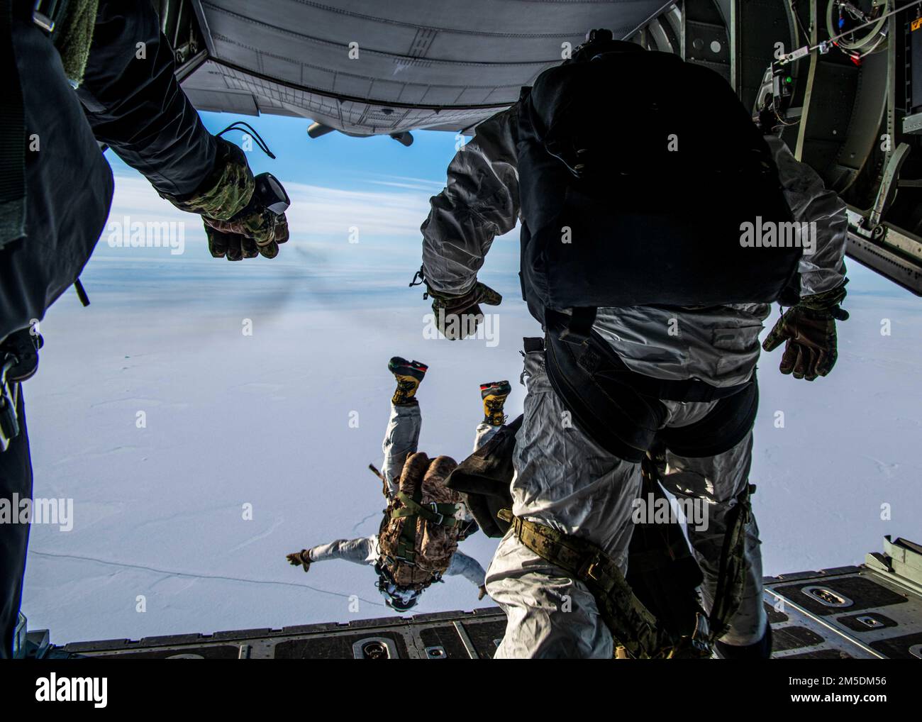 A Naval Special Warfare member performs a high-altitude low-opening ...