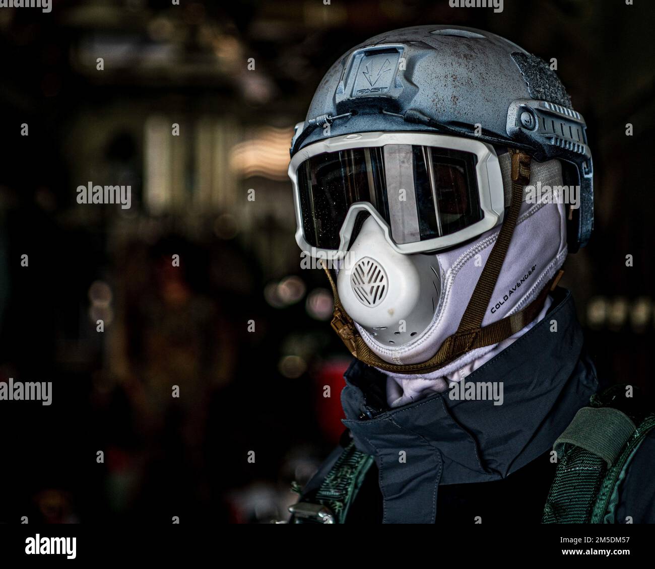A Naval Special Warfare jump master performs in-flight duties during a ...