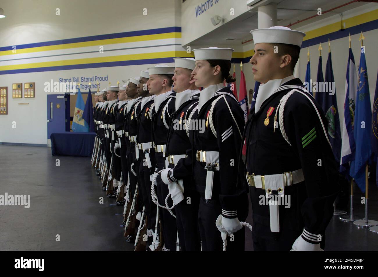 220304-N-ZZ000-1004 (March 4, 2022) Sailors stand in formation after receiving their aiguillette ...