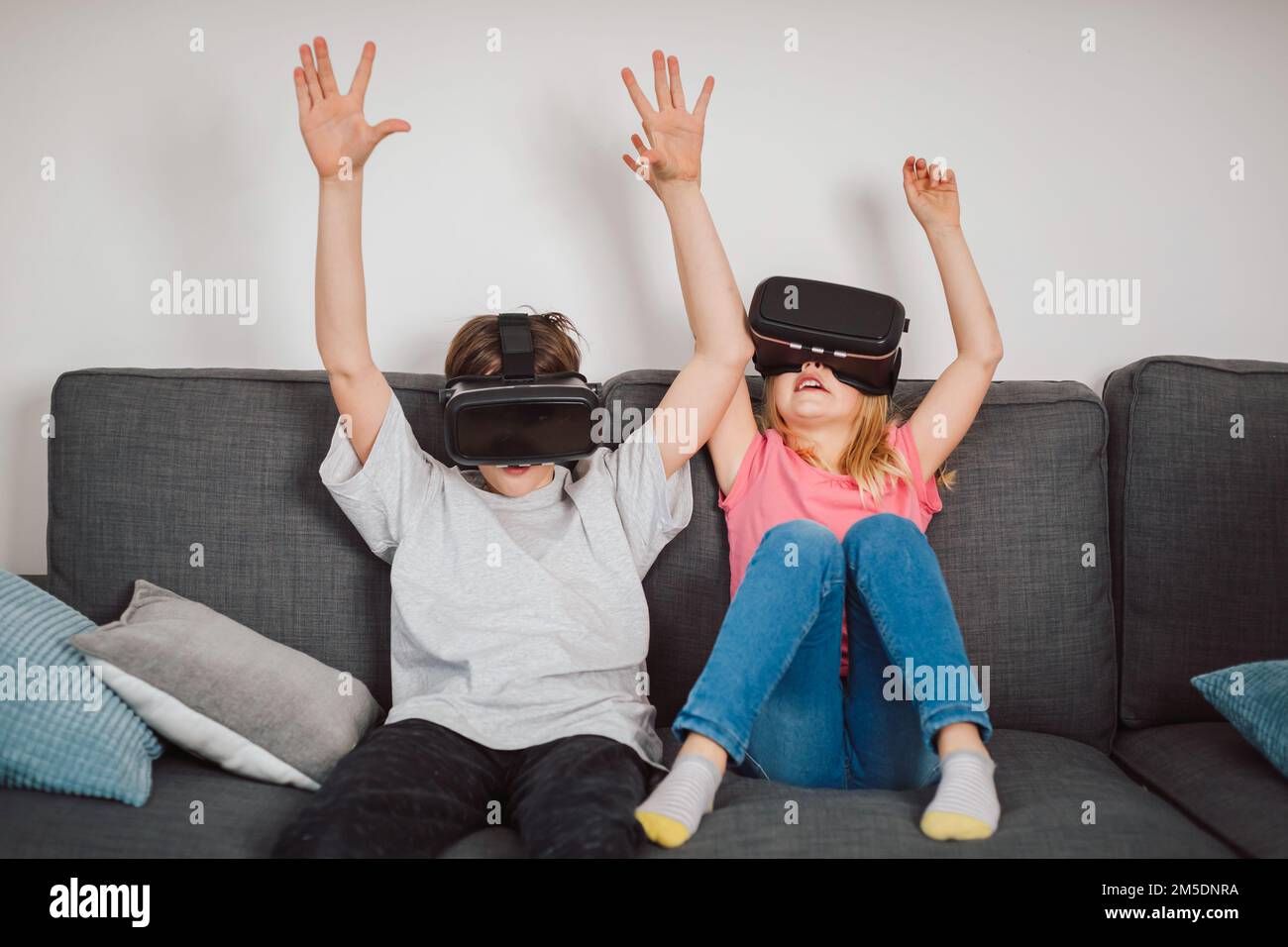 Two Caucasian children, brother, and sister having fun playing at home ...