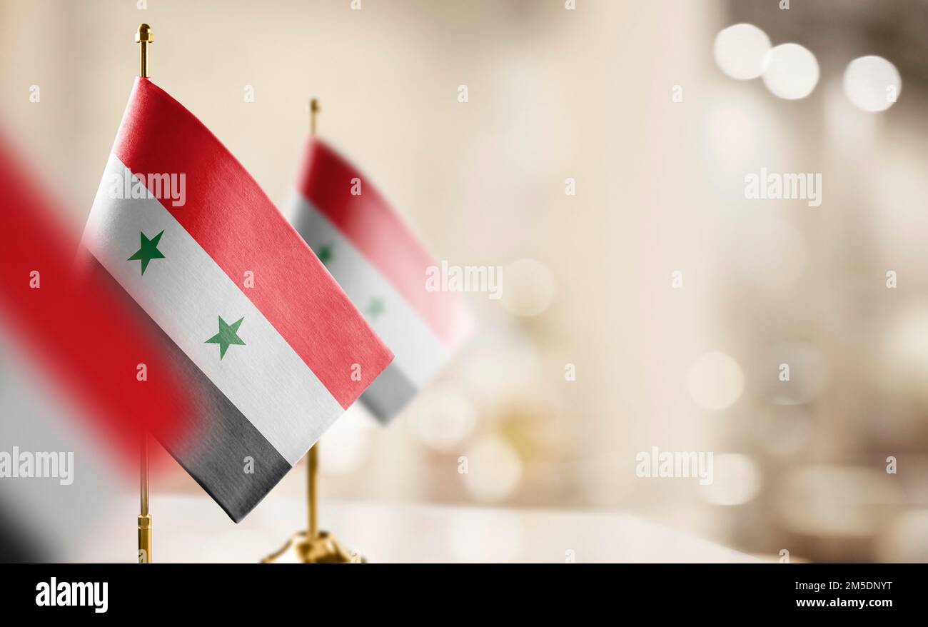 Small flags of the Syria on an abstract blurry background Stock Photo ...