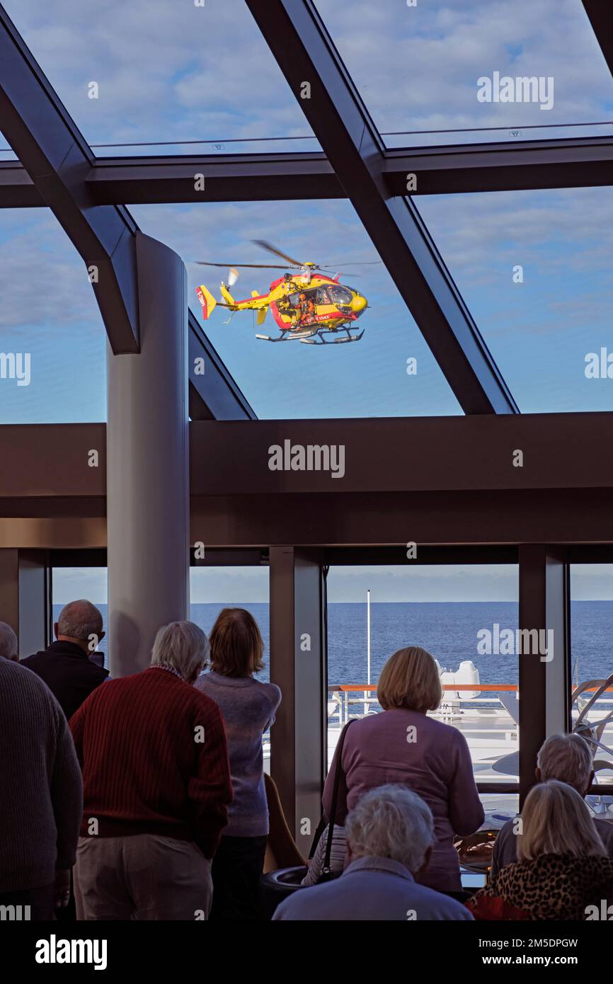 Passengers watch as a helicopter from the Sécurité civile arrives to ... Passengers watch as a helicopter from the Sécurité civile arrives to ...
