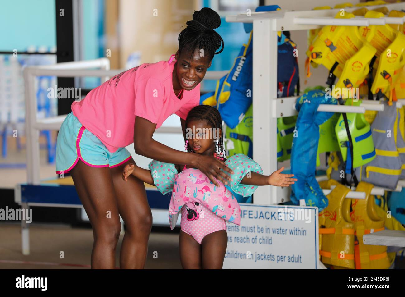 Mother and daughter prepare to get in the water at local swimming event ...