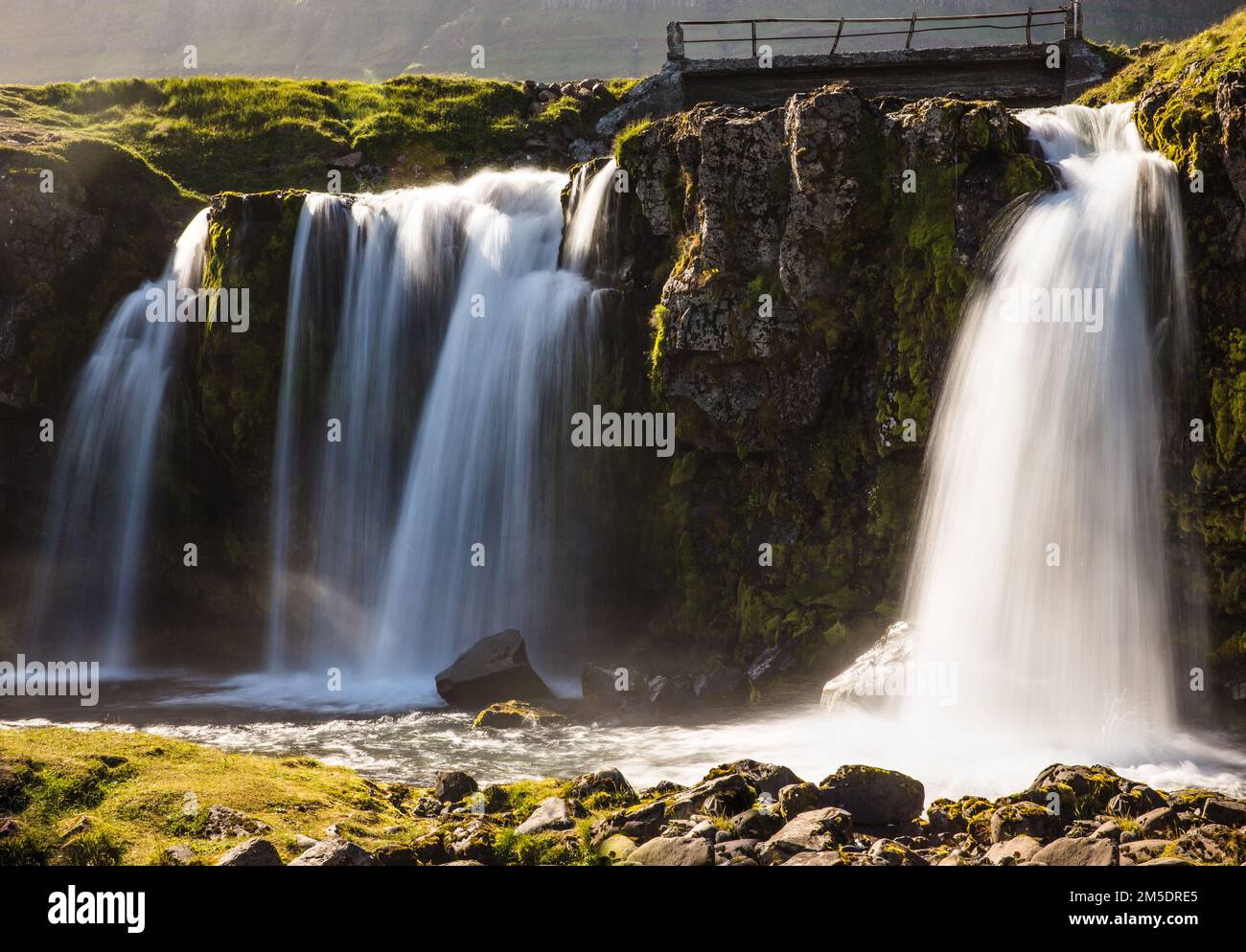 A scenic view of Kirkjufellsfoss waterfall with long exposure on a ...