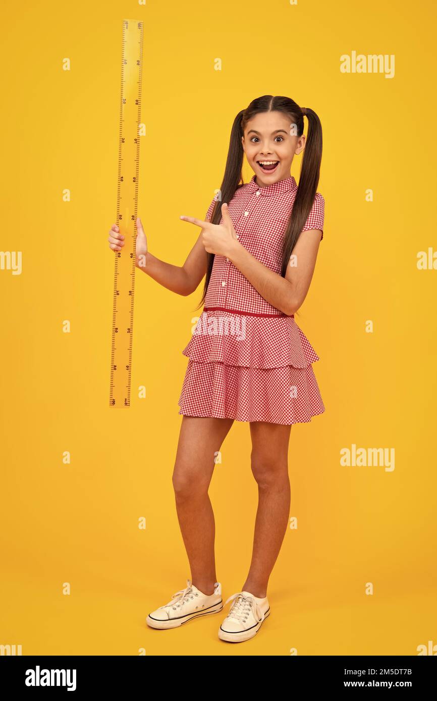 Teenager school girl study math or geometry lesson, measure the size ...