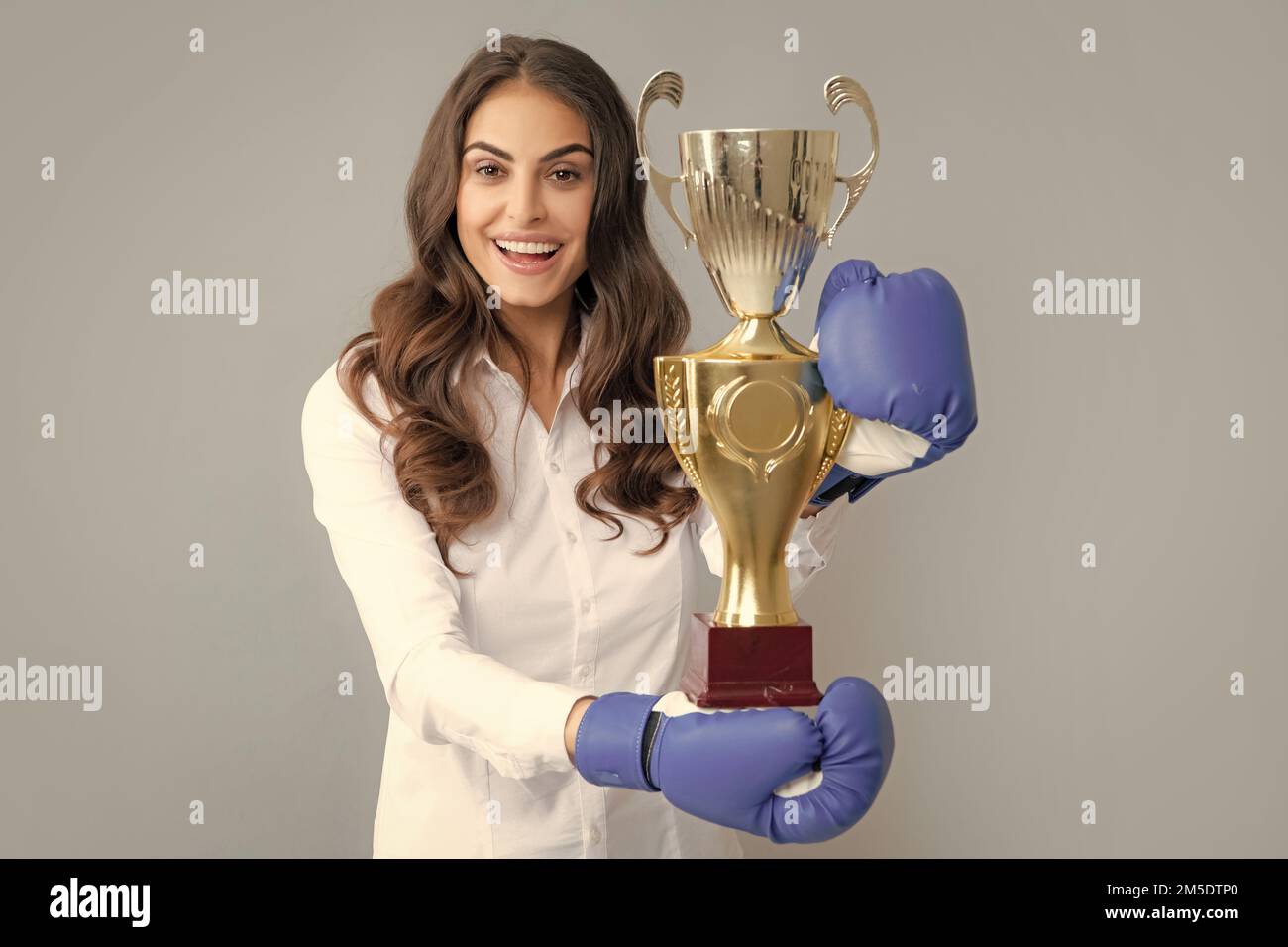 Woman in boxing gloves hold champion winner cup, trophy. Excited win ...