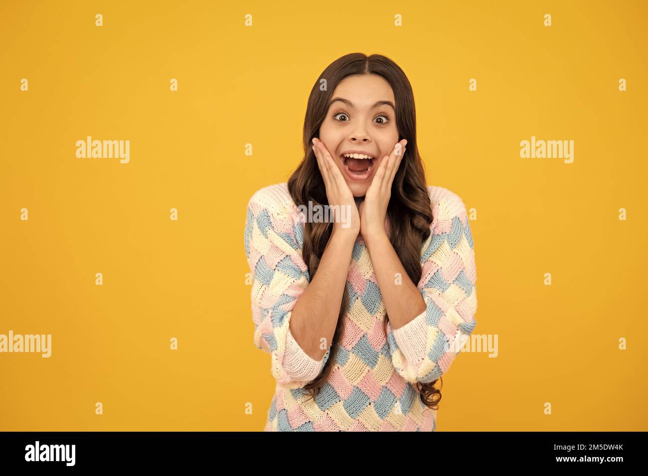 Shocked teenager child with amazed look on yellow background, amazement ...