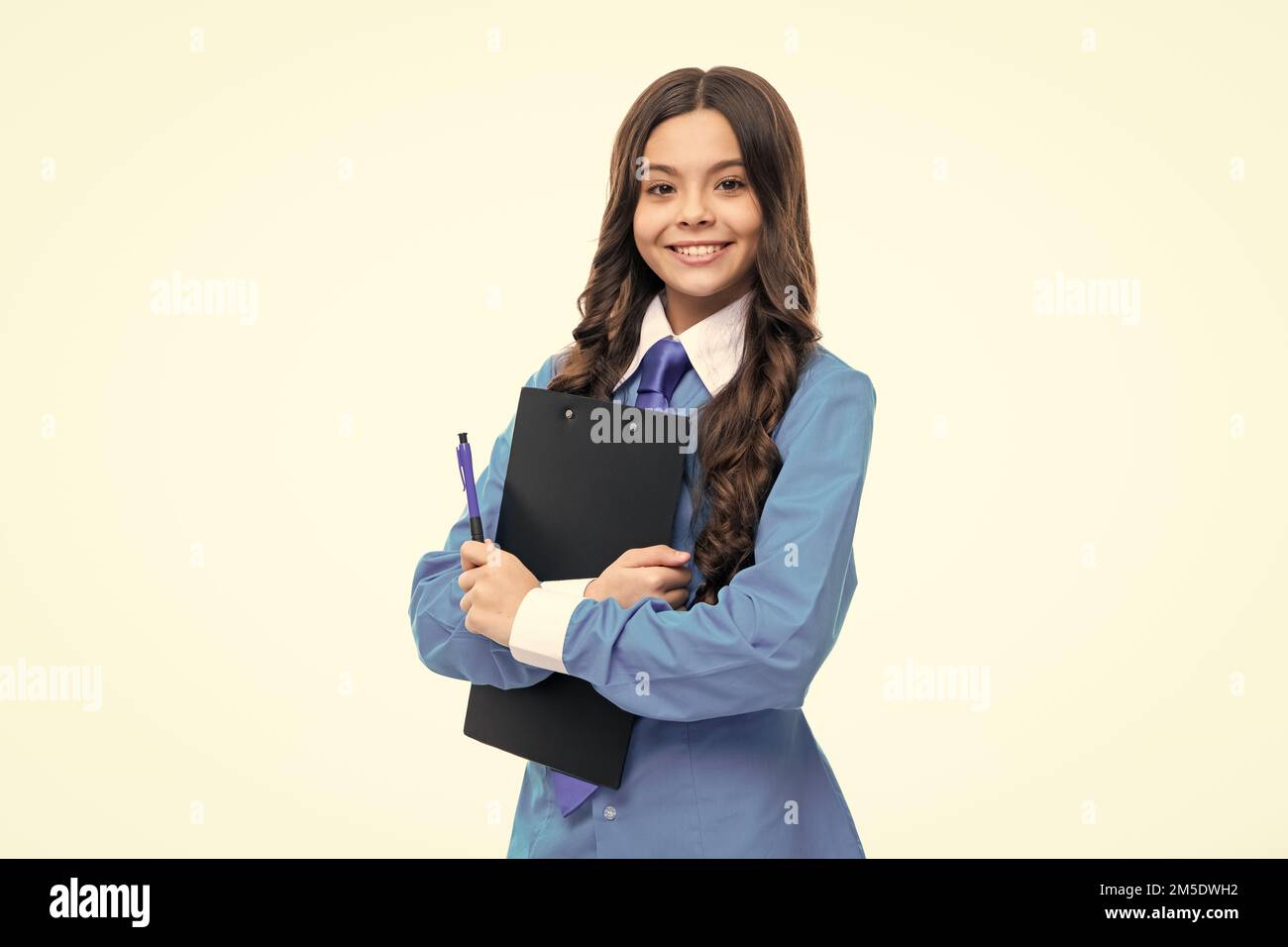Happy teenager girl wearing office uniform holding clipboard on white ...