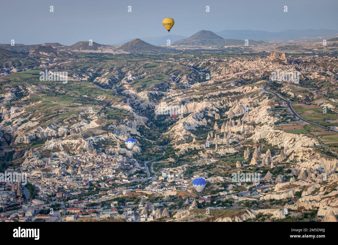 A beautiful shot of the hot air balloons over a landscape in the ...