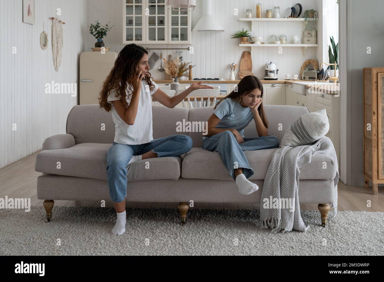 Stressed, nervous mother talking by phone complaining about bad ...
