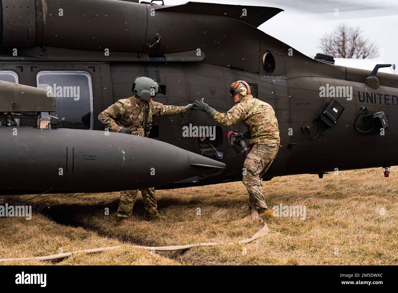 Soldiers prepare to refuel a UH-60 Black Hawk helicopter at a forward ...