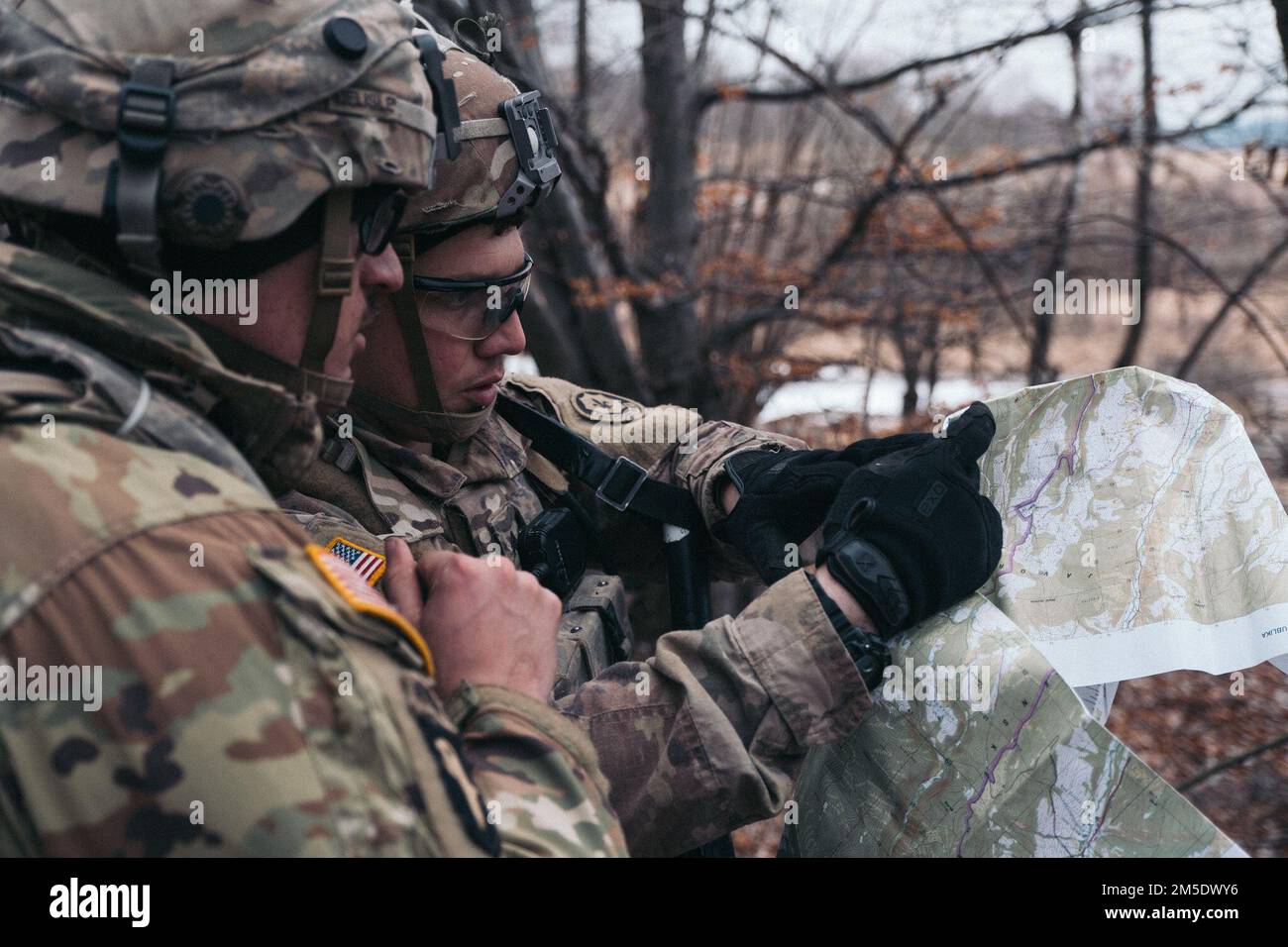 U.S. Soldiers assigned to the 2nd Cavalry Regiment read a map during ...