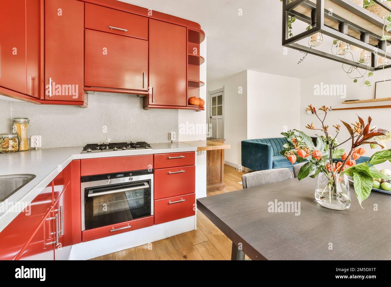 a kitchen with red cabinets and white counter tops in the center of the ...