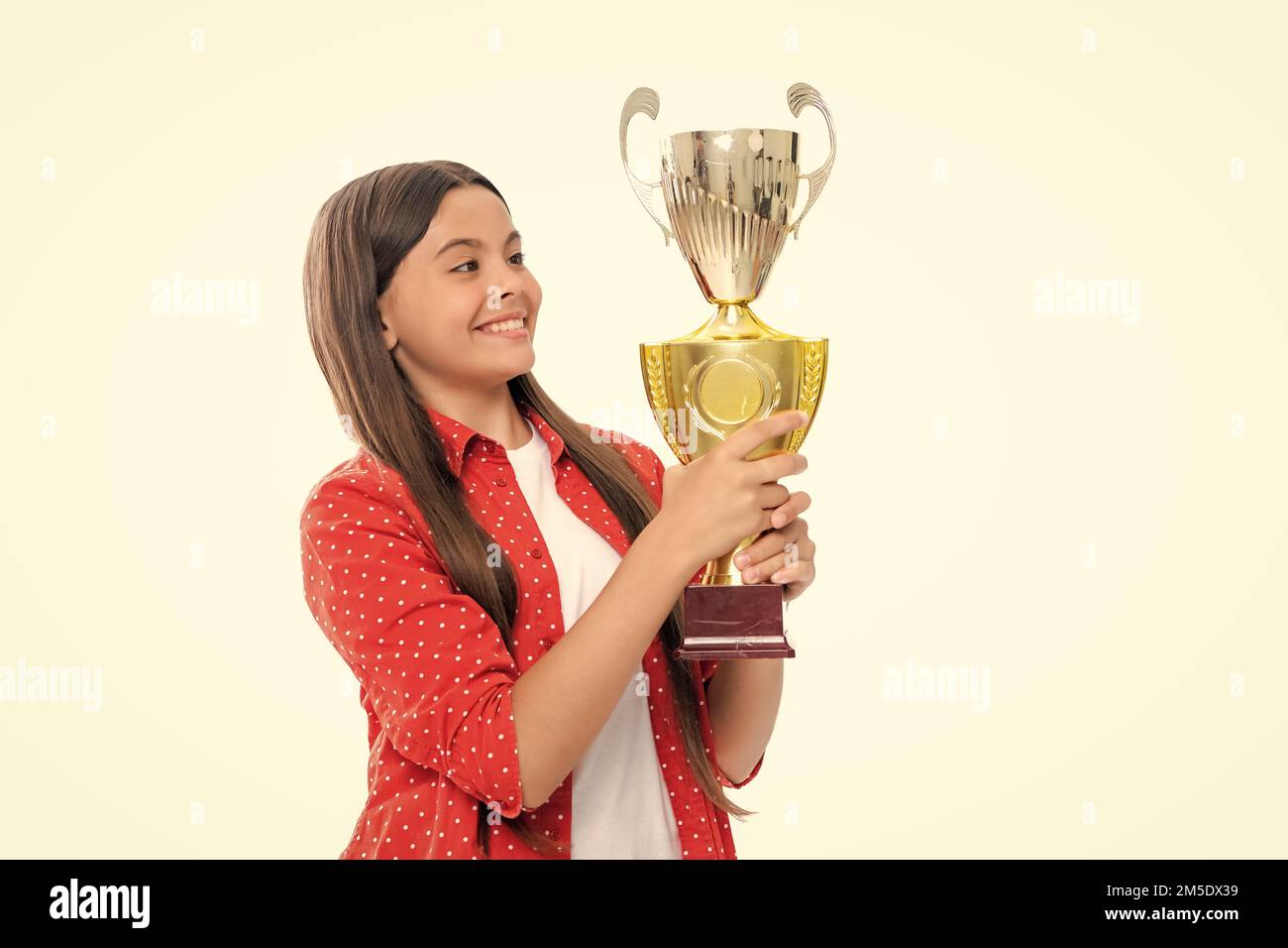 Teenage girl holding a trophy. Kid winner child won the competition ...