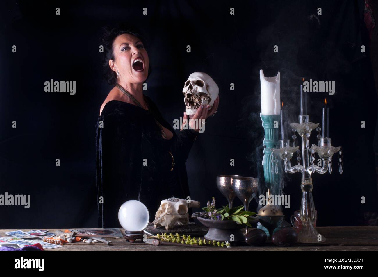 A dark, attractive witch practising her craft - John Gollop Stock Photo ...
