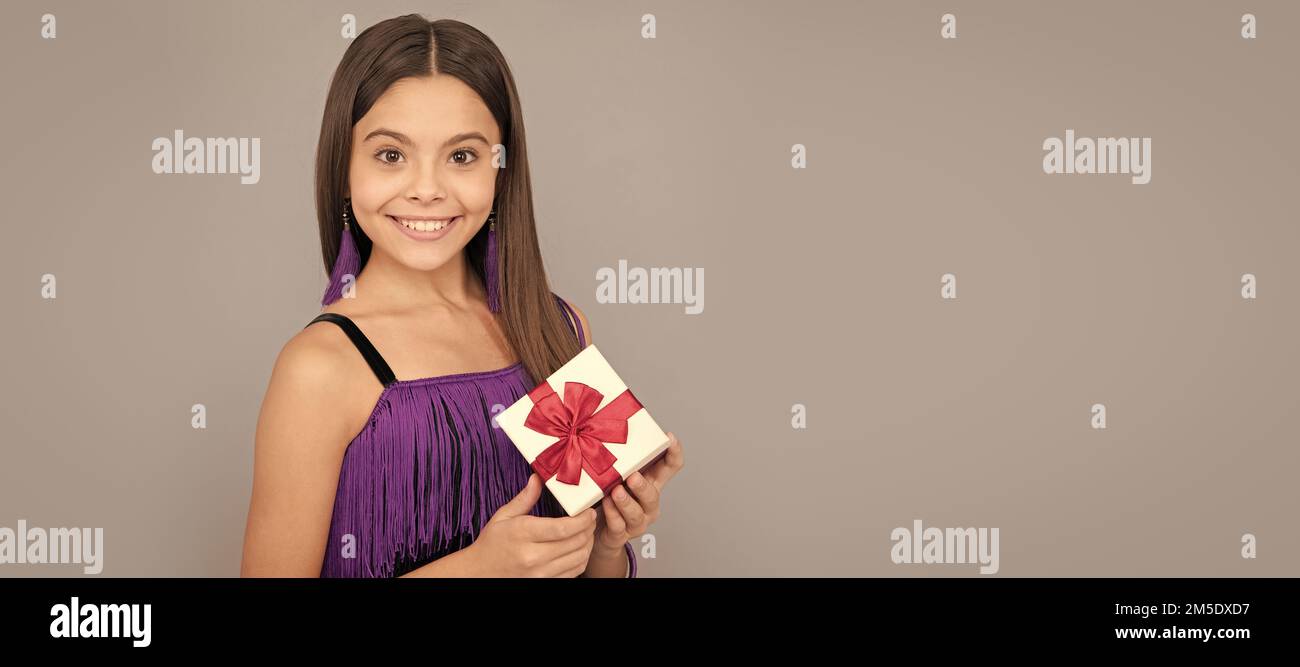 Child girl gift. We wrap good wishes. Birthday girl hold present box ...