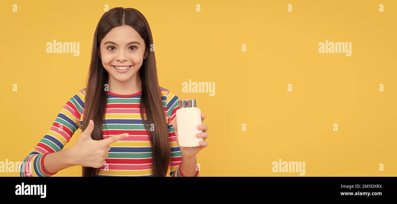 happy child pointing finger on natural food additives or vitamin pills ...