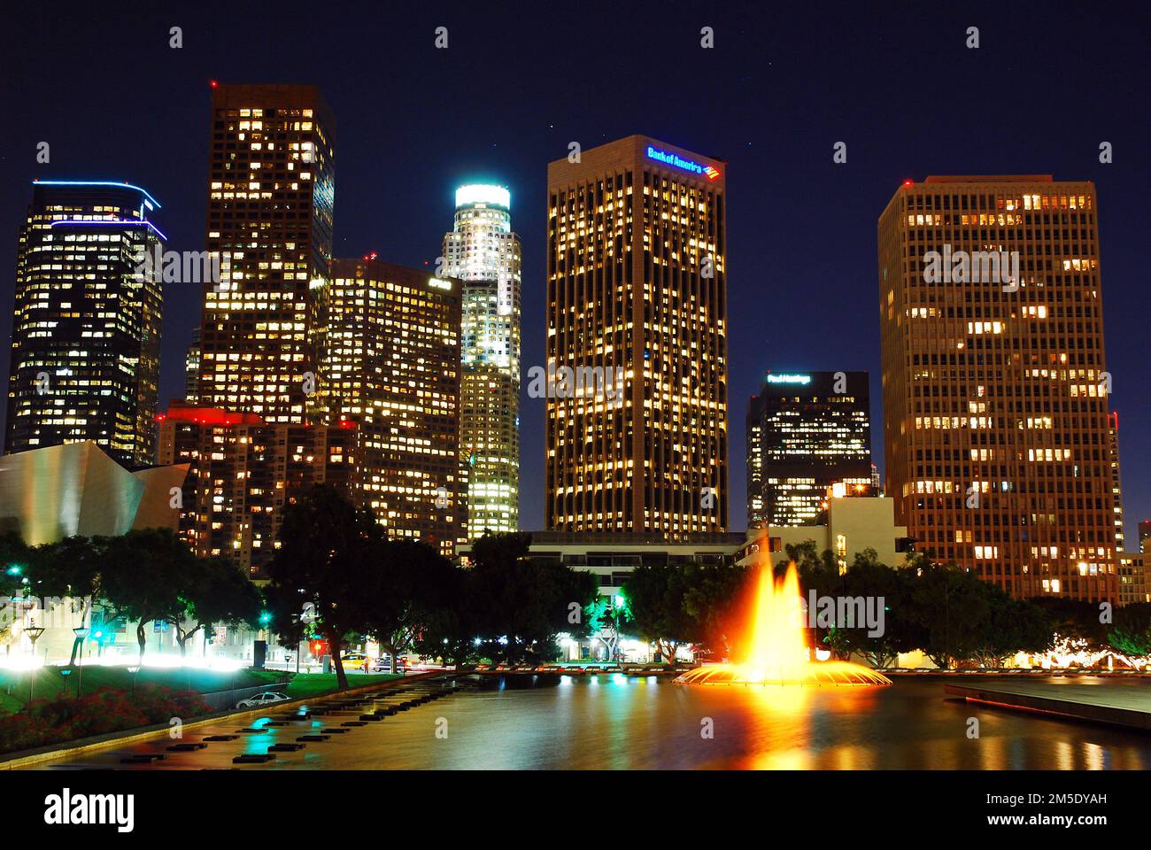 The lights of the Los Angeles skyline are illuminated at night, with a ...