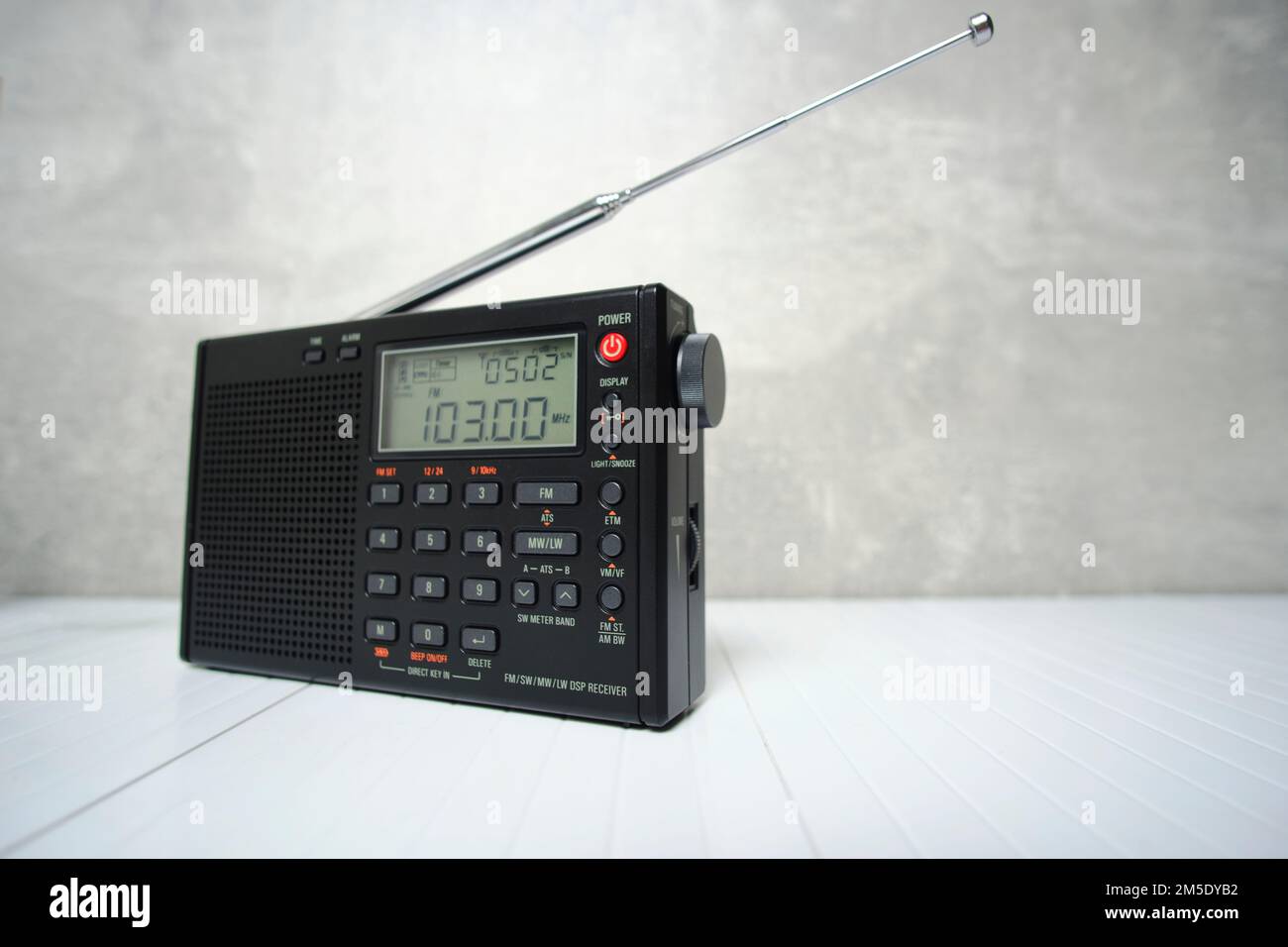 Digital radio receiver with elongated antenna gray concrete background ...