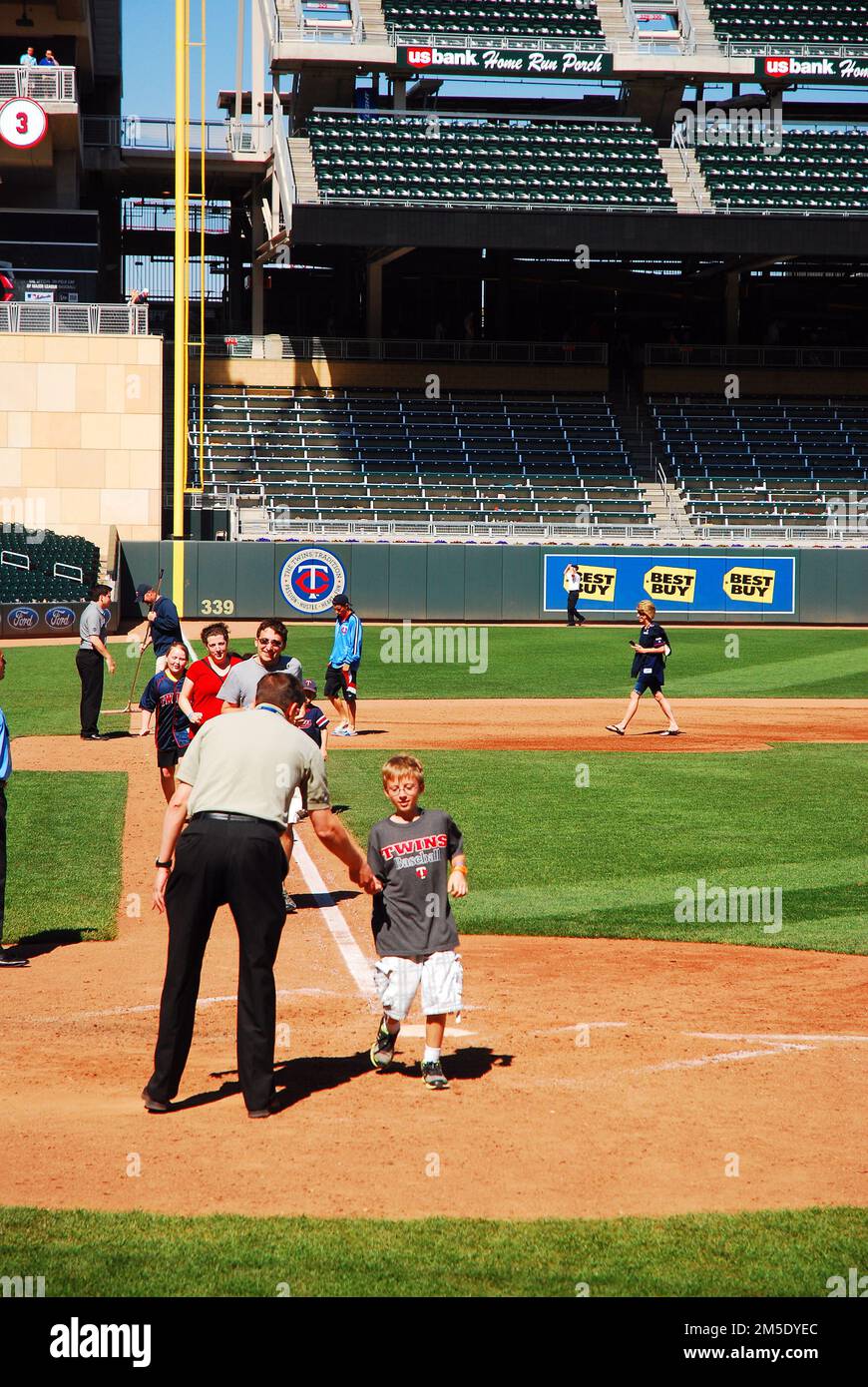 A young boy is greeted at home plate after rounded the bases in Target ...