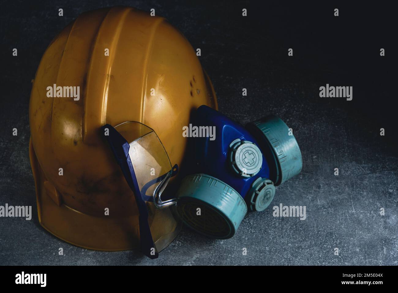 Respirator, goggles and miner protective helmet on concrete floor Stock ...