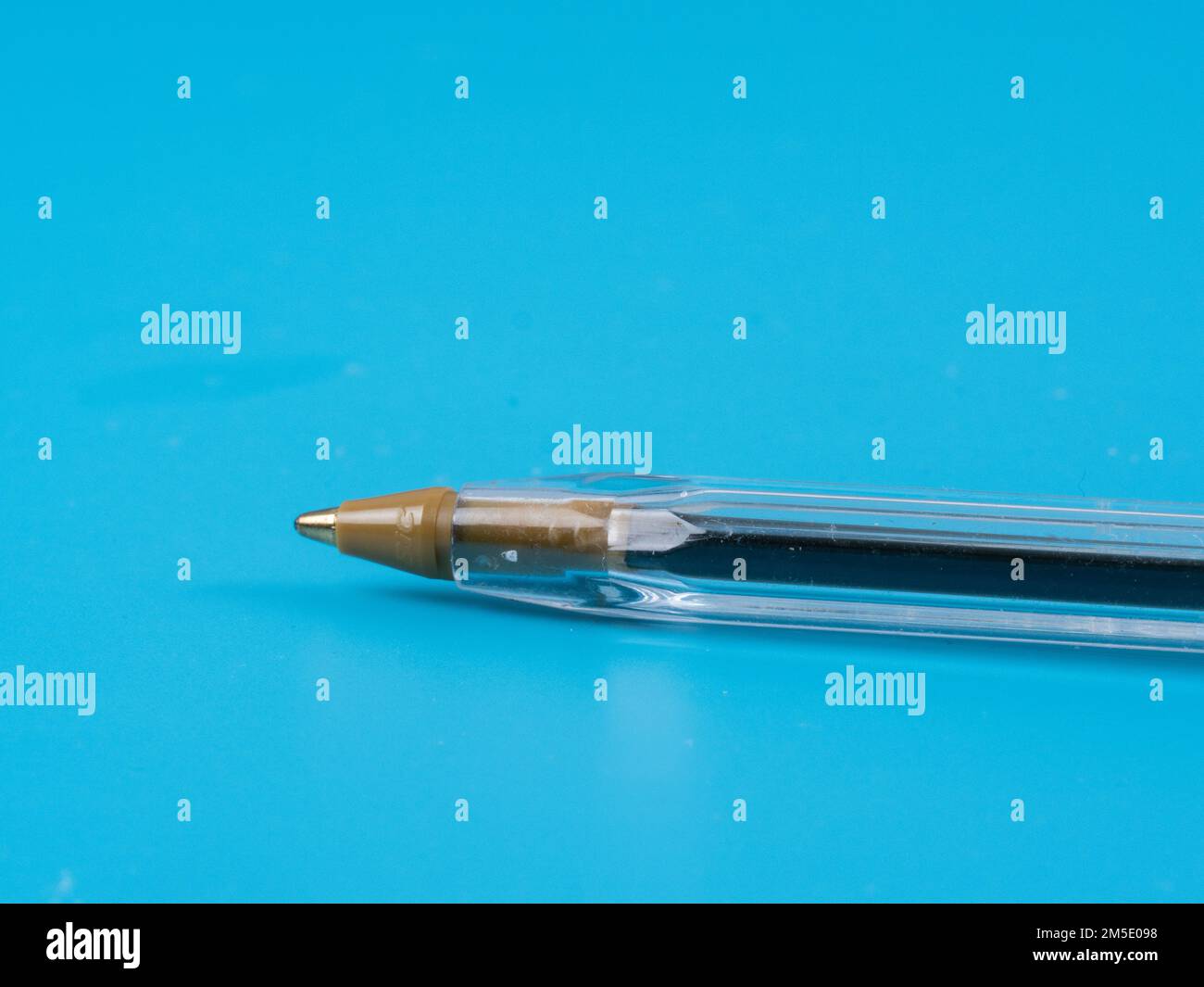 single ball tip biro pen isolated on a blue background Stock Photo - Alamy