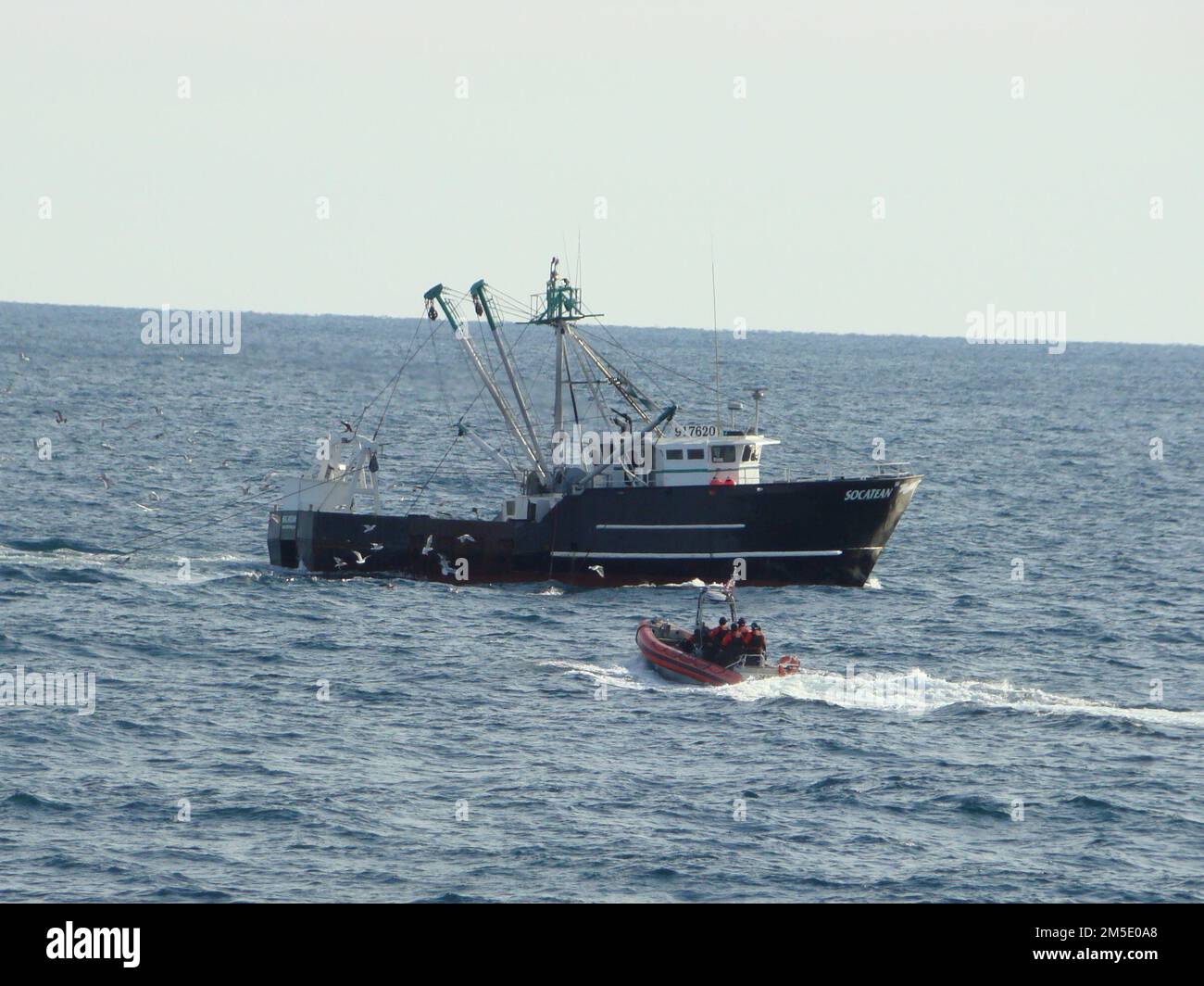 USCGC Tampa boarding team members approach the fishing vessel Socatean ...