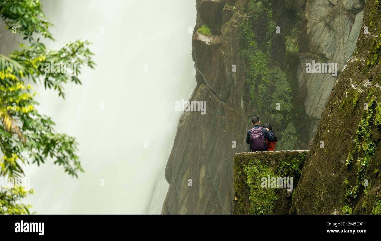 couple at a viewpoint to see the great waterfall in front of them, pail ...