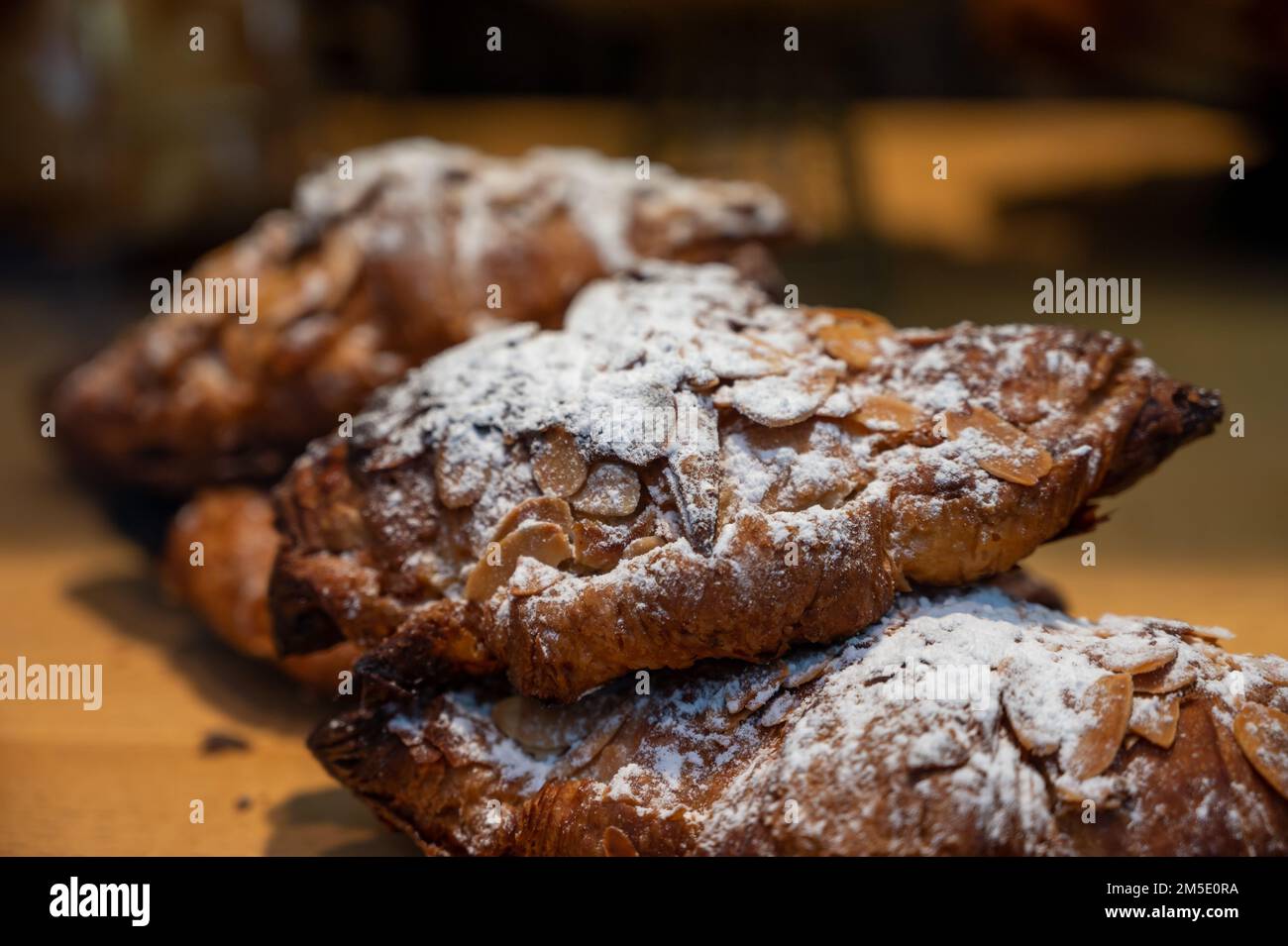 French sweet dessert pastry with almonds on display in french bakery ...