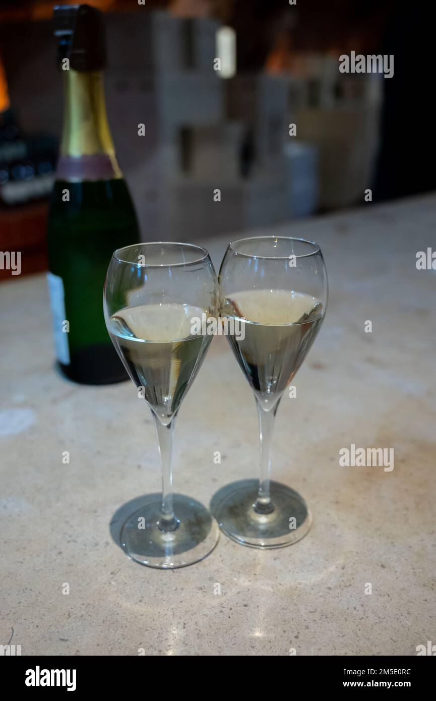 Tasting of rose champagne sparkling wine produced by traditional method in dark underground ...