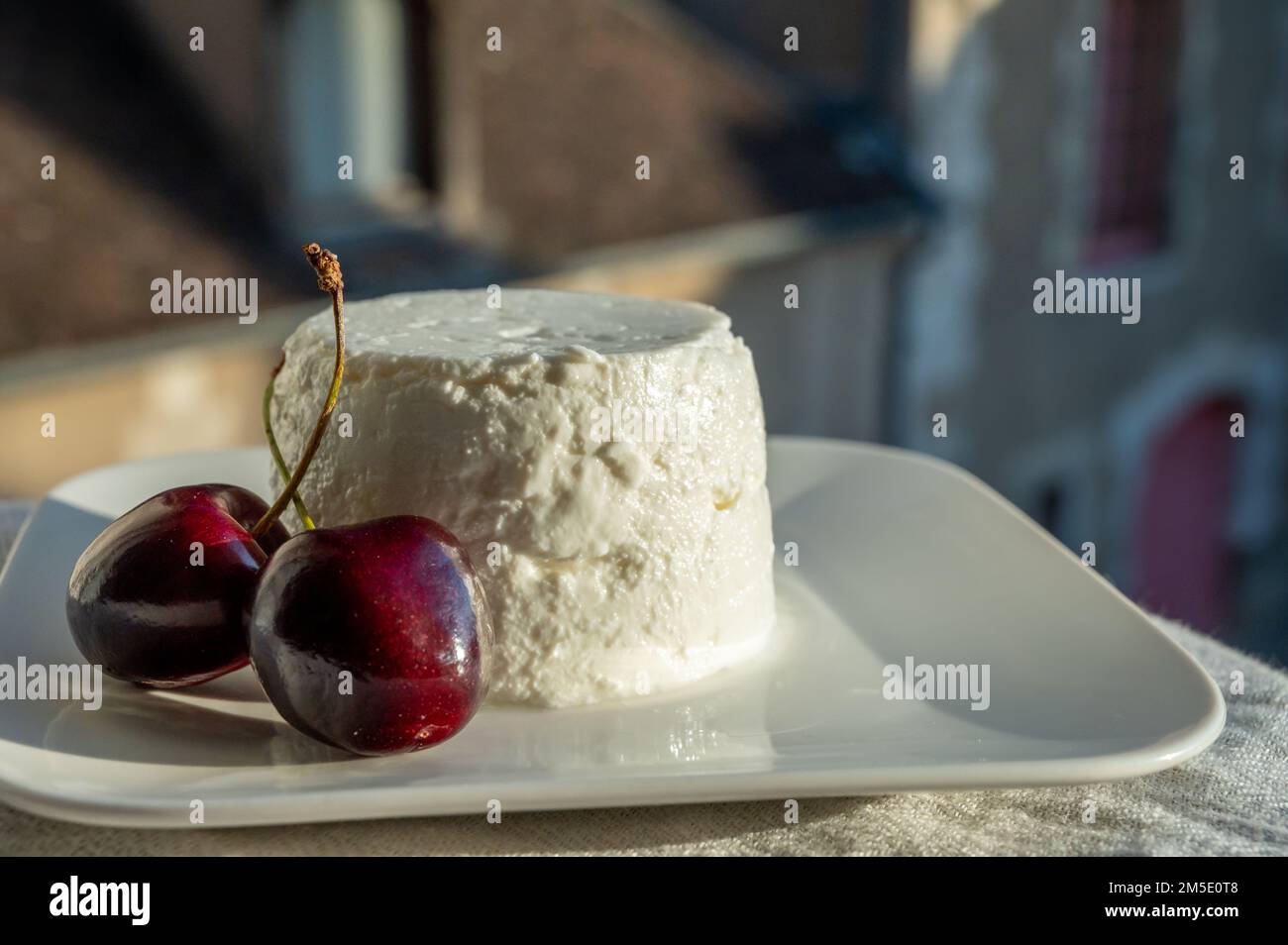 French soft white goat cheese served outdoor with fresh ripe cherry ...