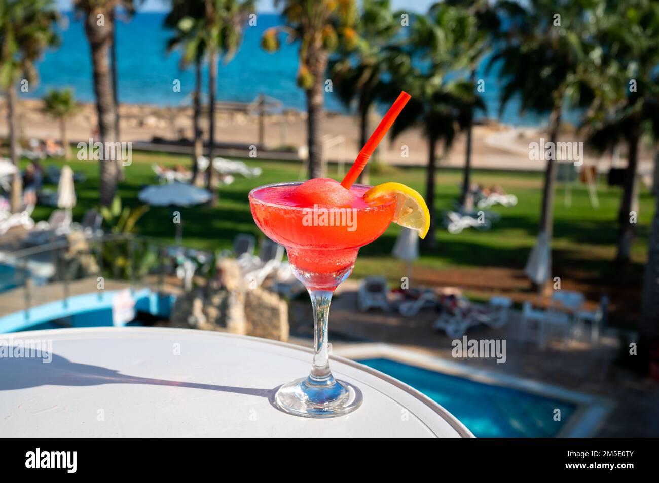Colourful frozen pink Strawberry daiquiri cocktail drink served in ...