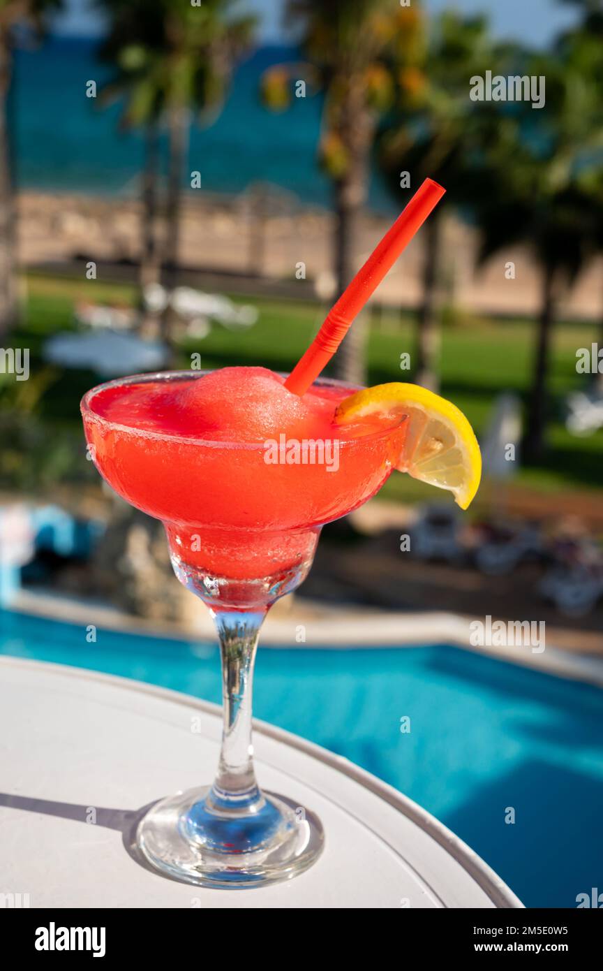 Colourful frozen pink Strawberry daiquiri cocktail drink served in ...