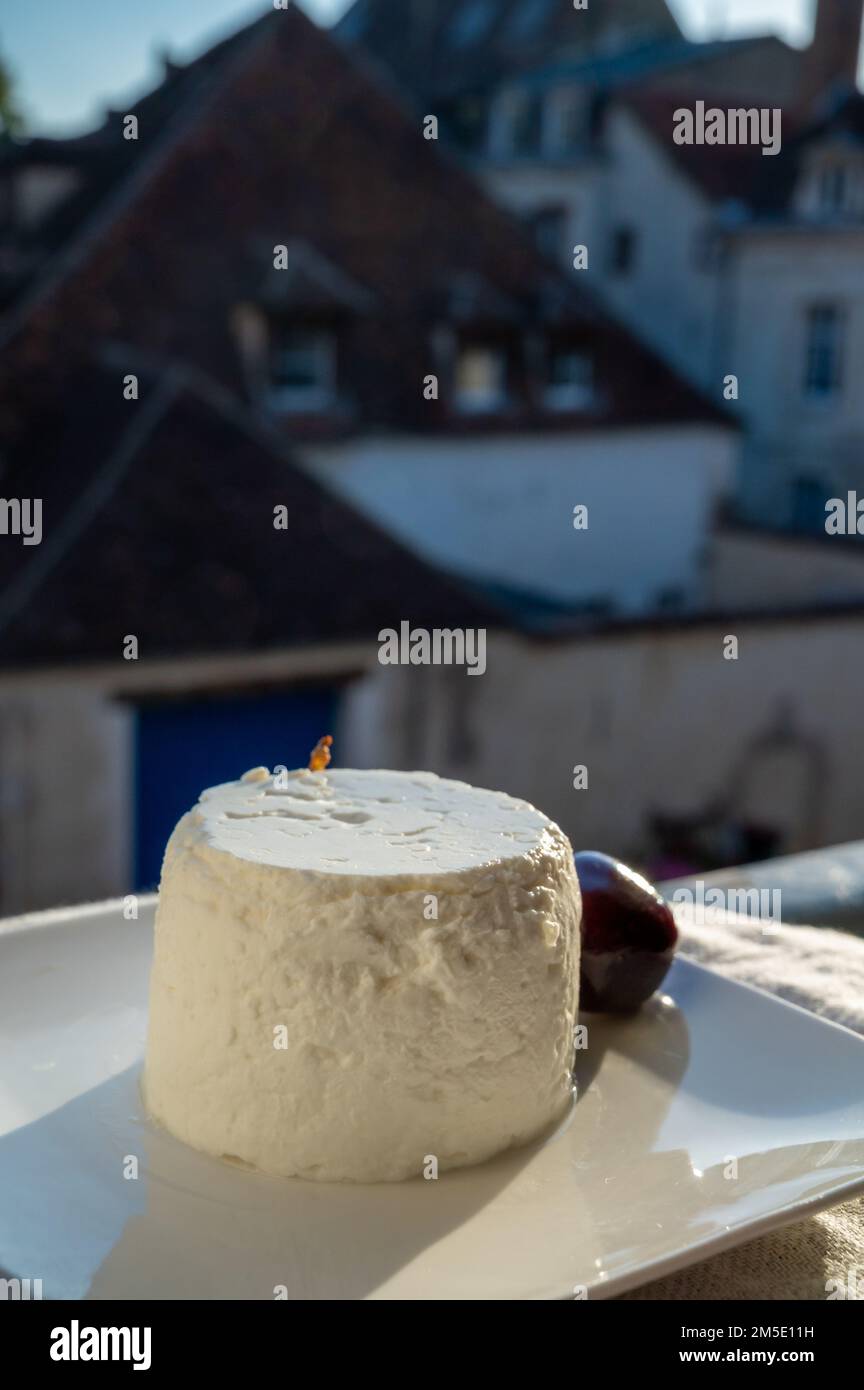 French soft white goat cheese served outdoor with fresh ripe cherry ...