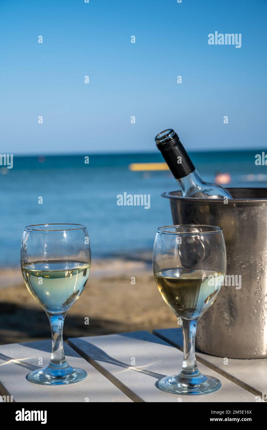 Drinking of cold white wine in beach bar, summer holidays, relax on ...