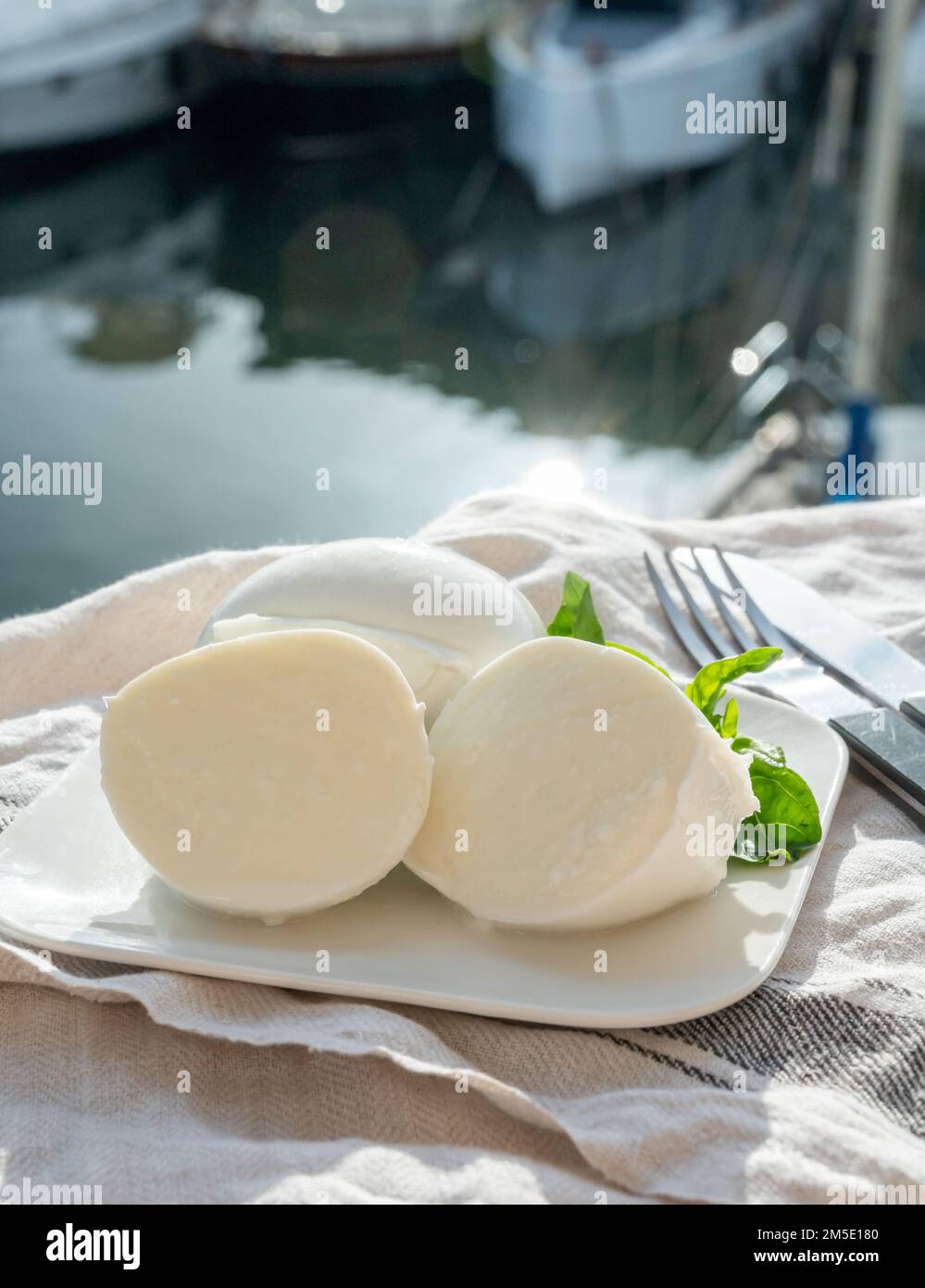 Tasting of white soft italian balls mozzarella cheese made from buffalo ...