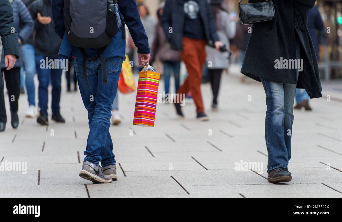 28 December 2022, Hessen, Frankfurt/Main: A man walks with a colorful ...