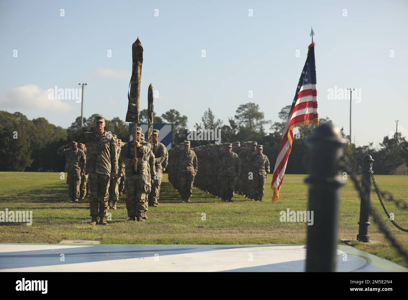 The 3rd Division Sustainment Brigade Soldiers salute he flag on ...