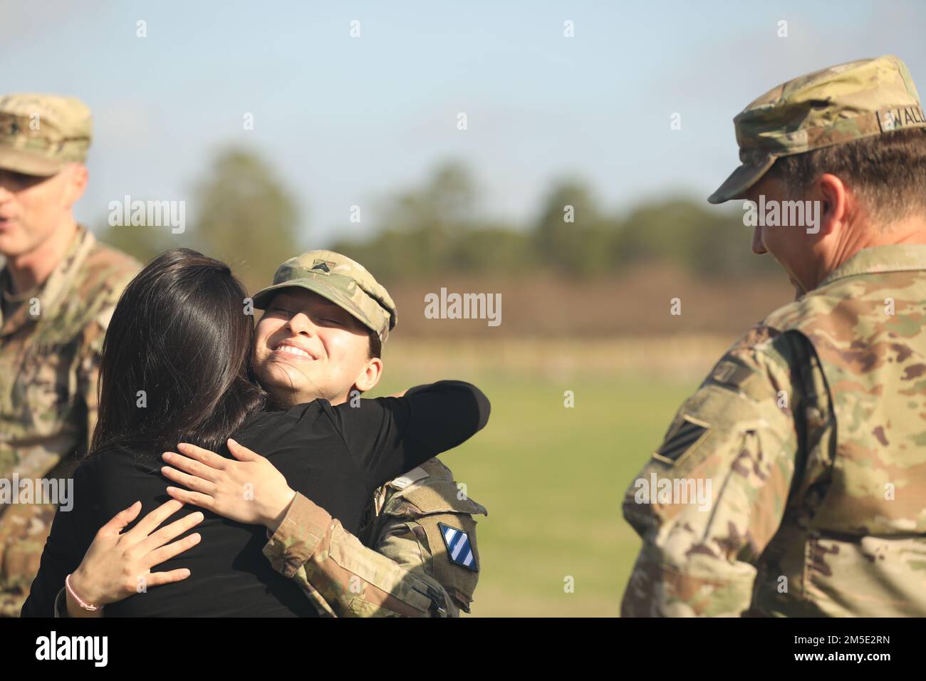 A 3rd Division Sustainment Brigade Soldier greets her family during a ...