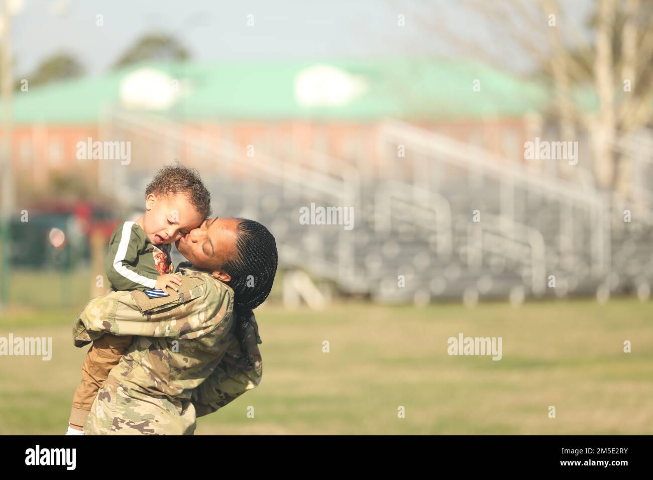 A 3rd Division Sustainment Brigade Soldier greets her son during a ...