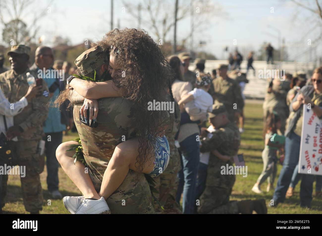 A 3rd Division Sustainment Brigade Soldier greets his family during a ...
