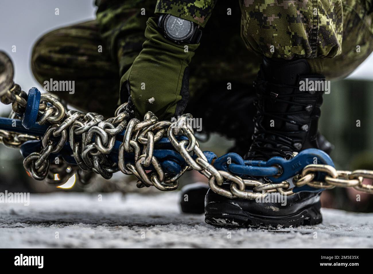 A Canadian Army soldier chains the load on a mack load handling system ...