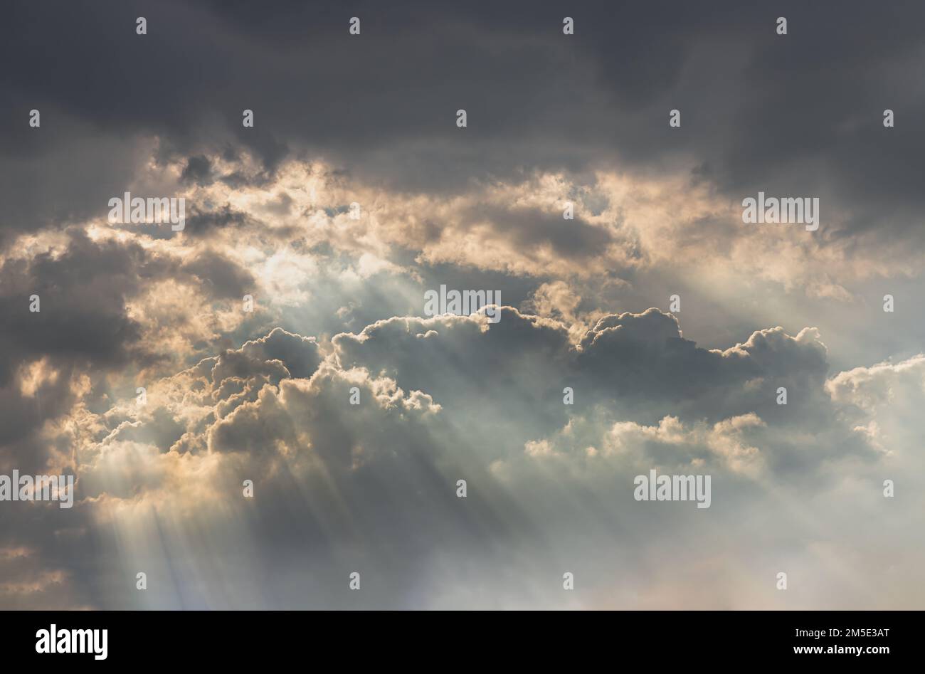 The sun's rays passing through the clouds and shining form an ...