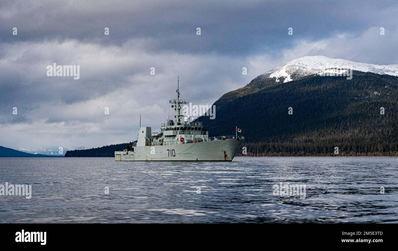 Her Majesty's Canadian Ship Brandon sails along the coastline of Alaska ...