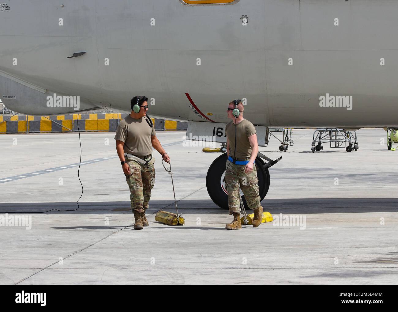 U.S. Air Force crew chiefs remove the tire chocks from an E-3 Sentry ...