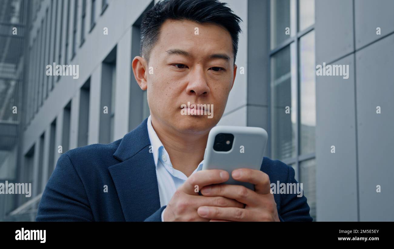 Bottom view pensive Asian Korean adult man middle-aged 40s businessman ...